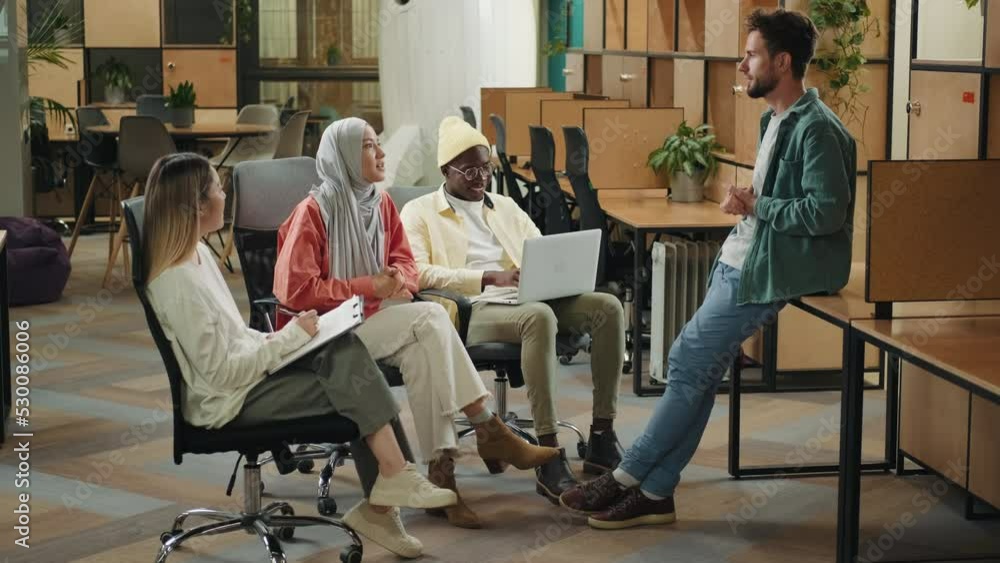 Multiethnic business team of coworkers are discussing a project in a ...