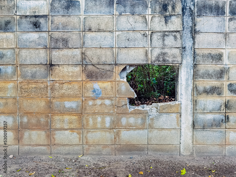 Dirty old eroded cracked plaster cement block fence. Concrete block ...