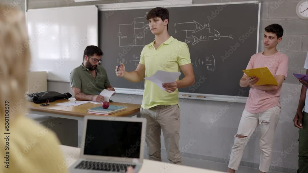 Multiracial group of young students giving a presentation in classroom ...
