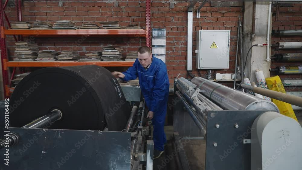 Worker inserting the sustainable fabric material into the processing ...