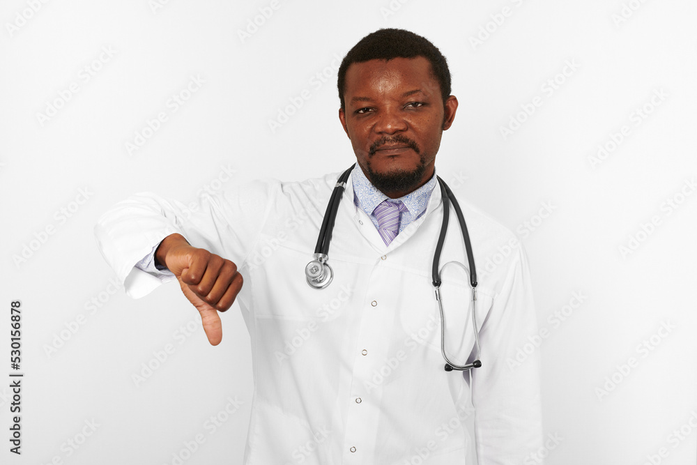 Smiling black bearded doctor man in white robe with stethoscope shows ...