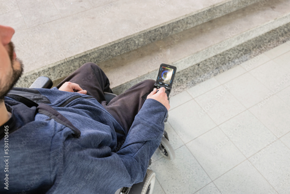 Man with disability on wheelchair stopped in front of staircase ...