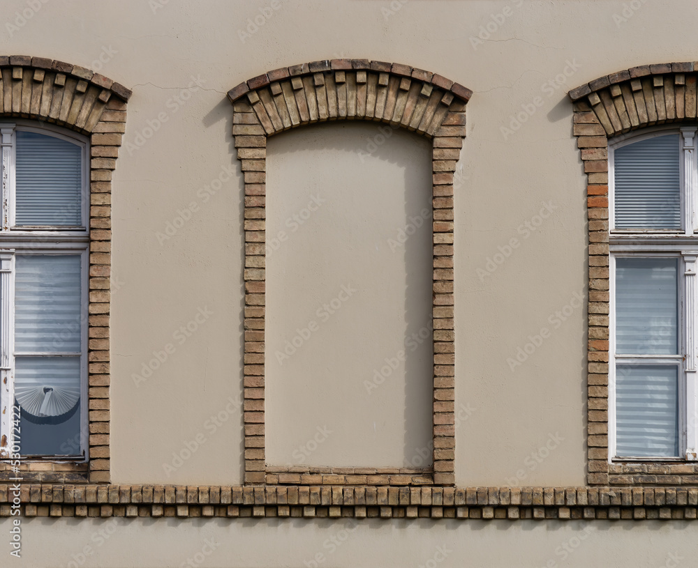 Front view of bricked up vintage style window on the brown facade Stock ...