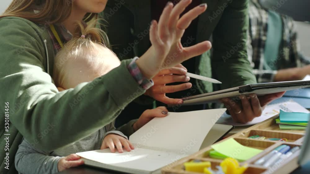 Inclusion business woman, mother with baby in office planning, working ...