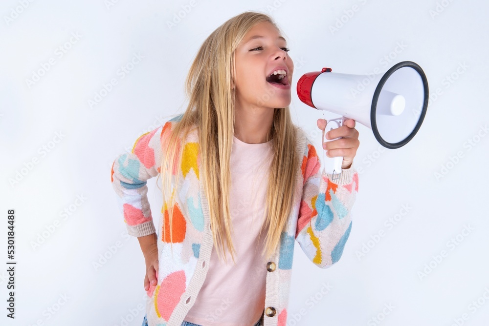 Funny little kid girl wearing colorful yarn jacket over white ...