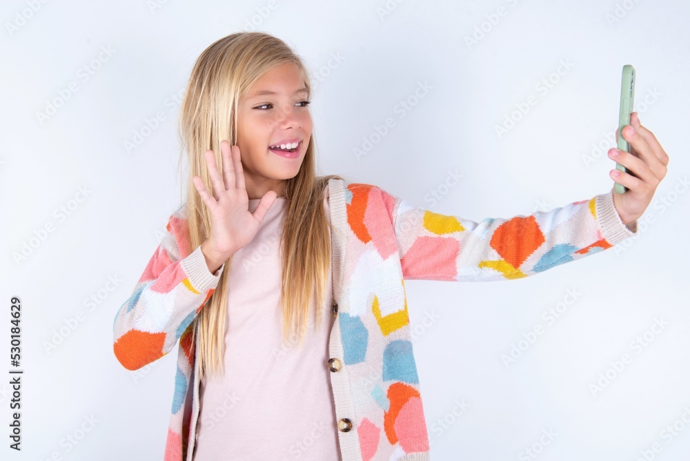 little kid girl wearing colorful yarn jacket over white background ...