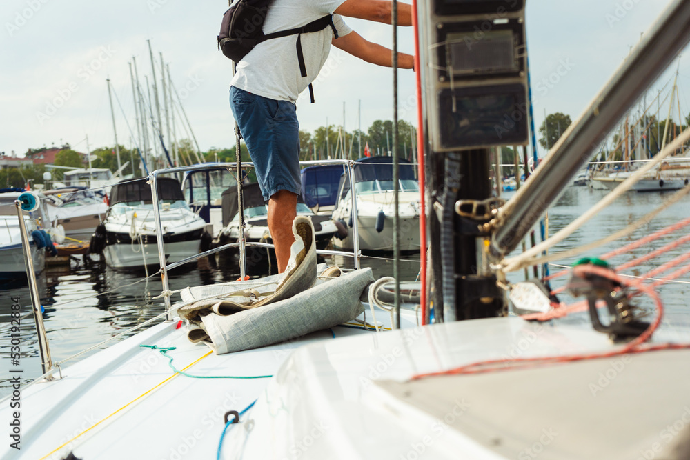 beginner courses for men on a sailing yacht. a man pulls a rope from a ...