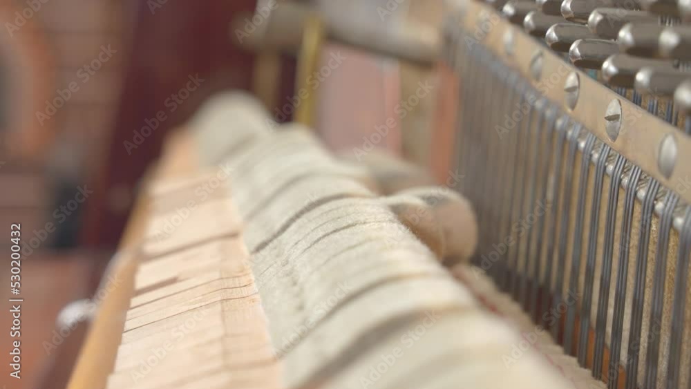 Movement of piano keys of hammers when playing melody. Side view of ...