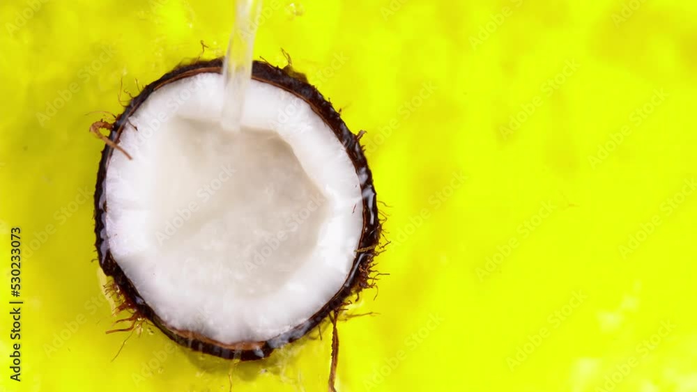 Coconut milk pouring, dripping coconut water, drops of coconuts oil ...