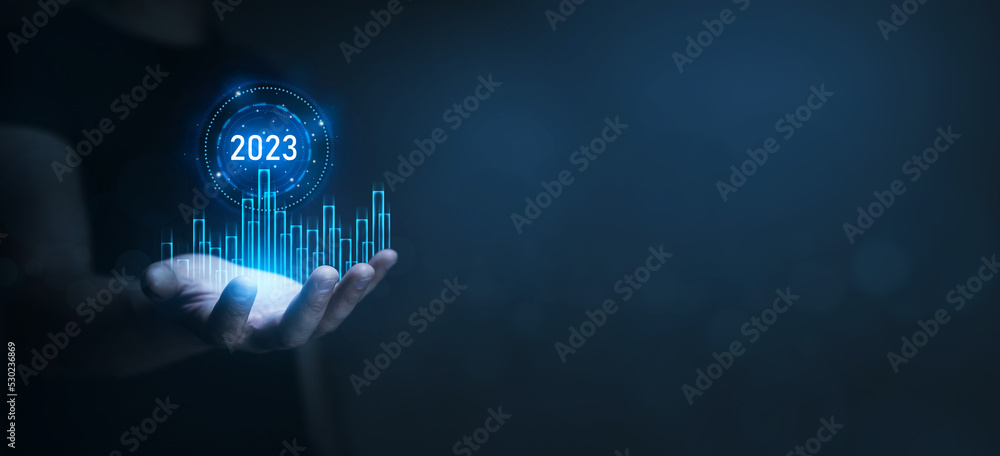 Businessman holding growth graph a year 2023 of business and data ...