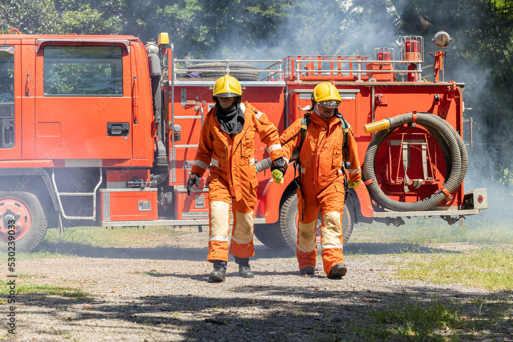 Firefighters wearing helmets with fire safety equipment Use Twirl ...
