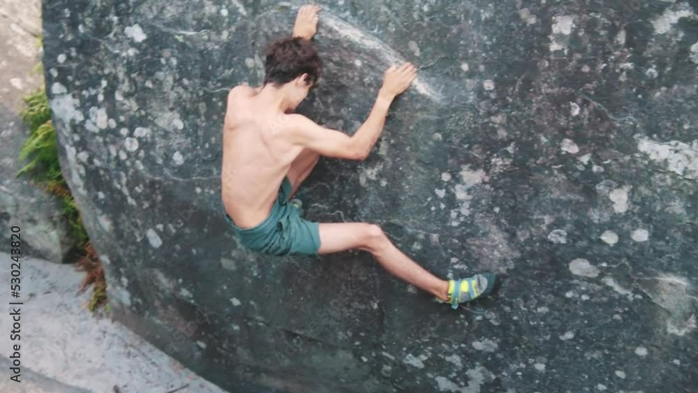 young shirtless male climbing boulder fontainebleau hangs on edge ...