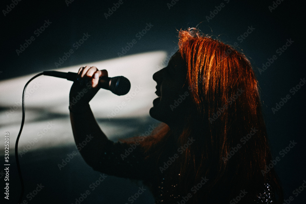 Silhouette Profile Of Female Singer Woman Holding Microphone Excited