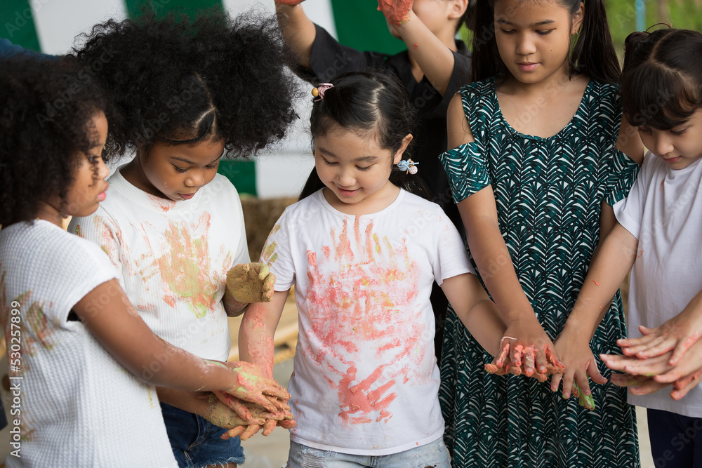 Group of children playing colourful water colours and colour stain on ...