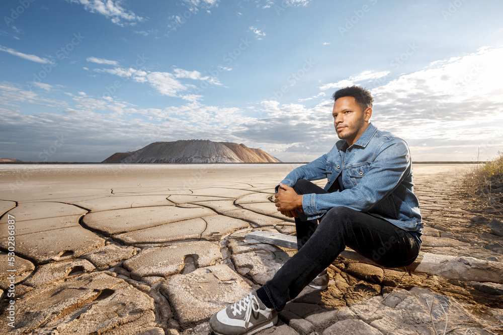 Handsome american male fashion model in stylish clothes, posing sitting ...