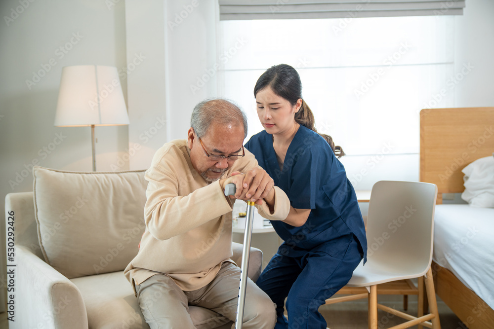 A nurse is caring for an elderly person using a walking cane during ...