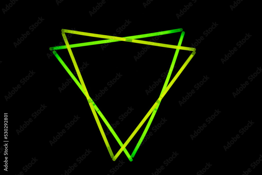 Image of vibrant triangles green neon glow sticks over black background ...