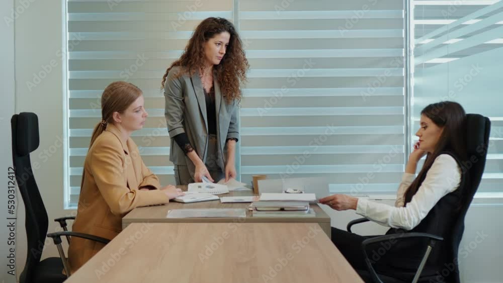 Angry buisness woman boss shouting at her employees during meeting ...