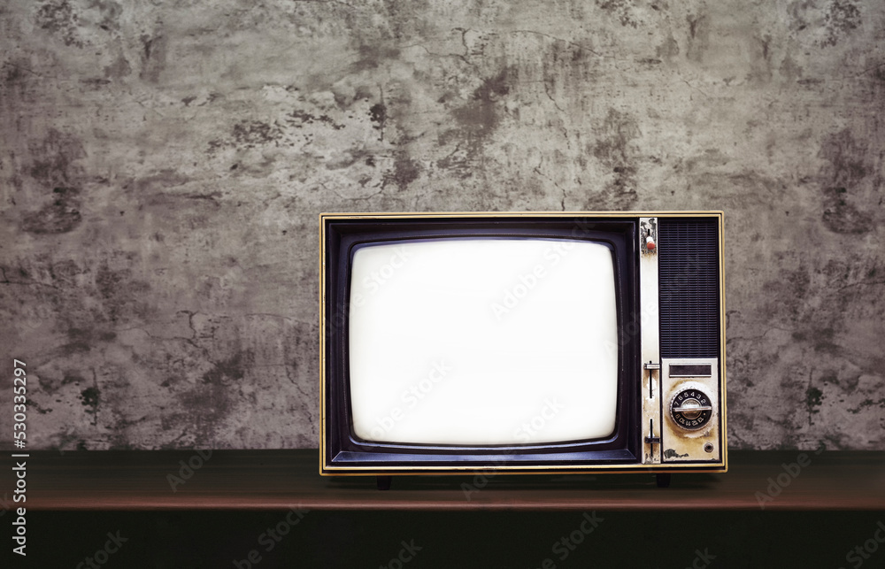 Vintage old TV on wooden table with concrete wall background with copy ...