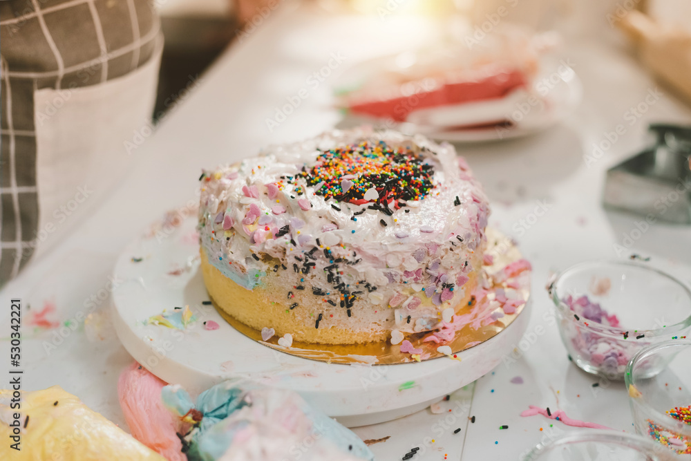 Messy kitchen with homemade birthday cake made from kids. Kitchen with ...