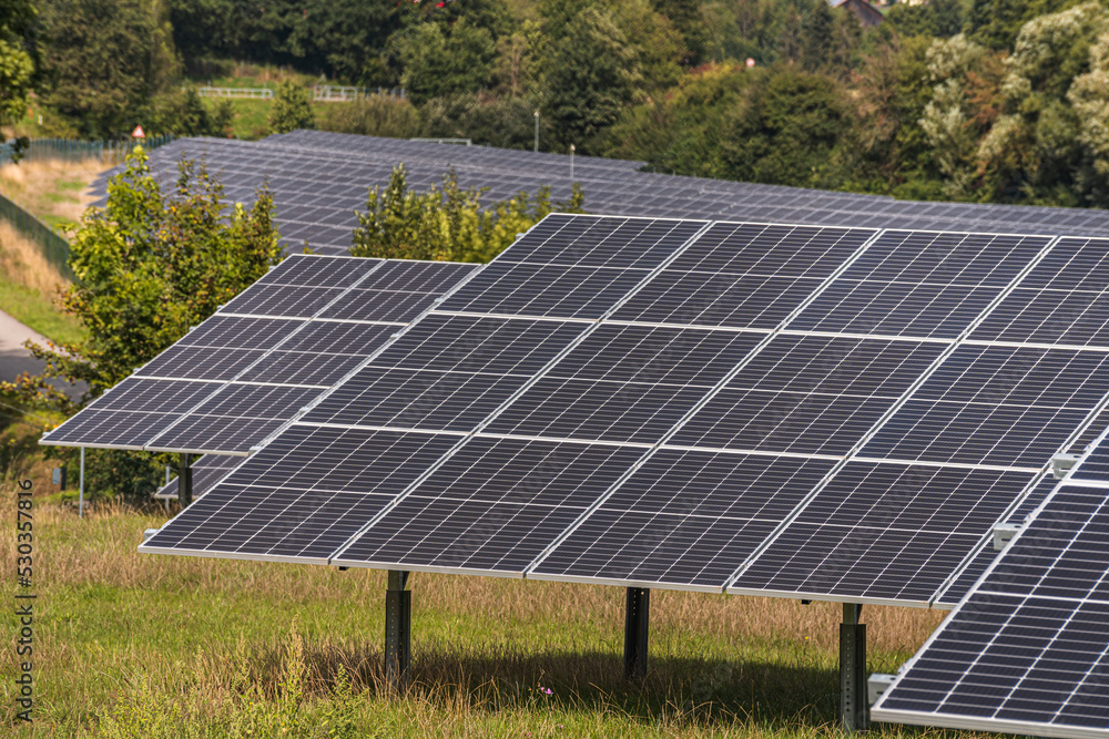 Solar panels (solar cell) in solar farm with sun lighting to create the ...