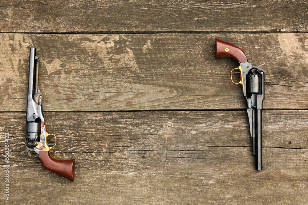 Two black powder revolvers Colt Army and Remington New Army on an old ...