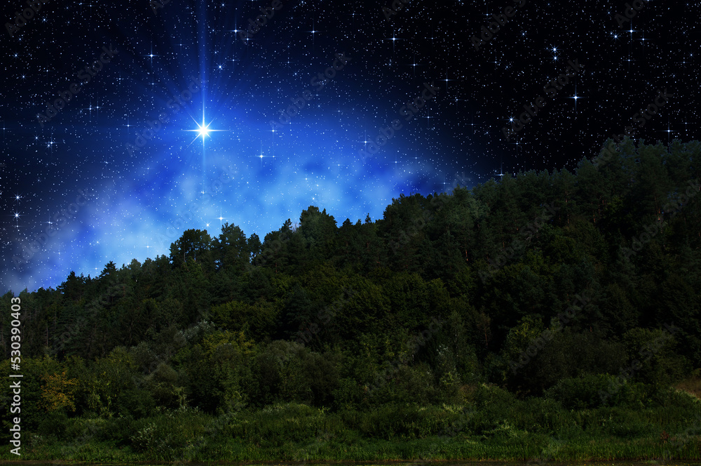Birth of new star in the starry night sky beyond the mountains covered ...
