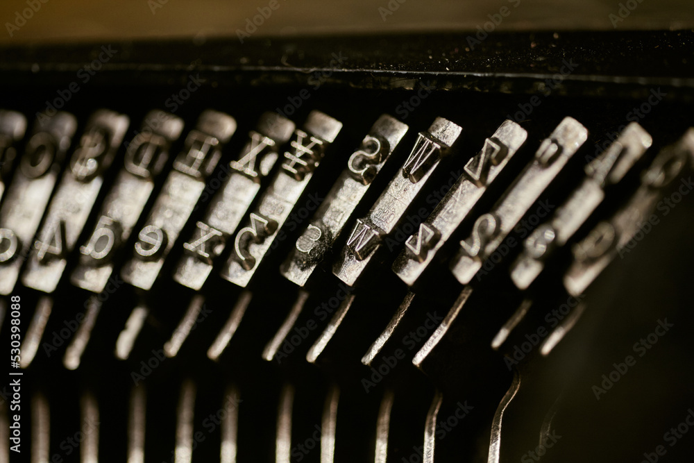 Closeup of old typewriter plates strikers strykers with letters and ...