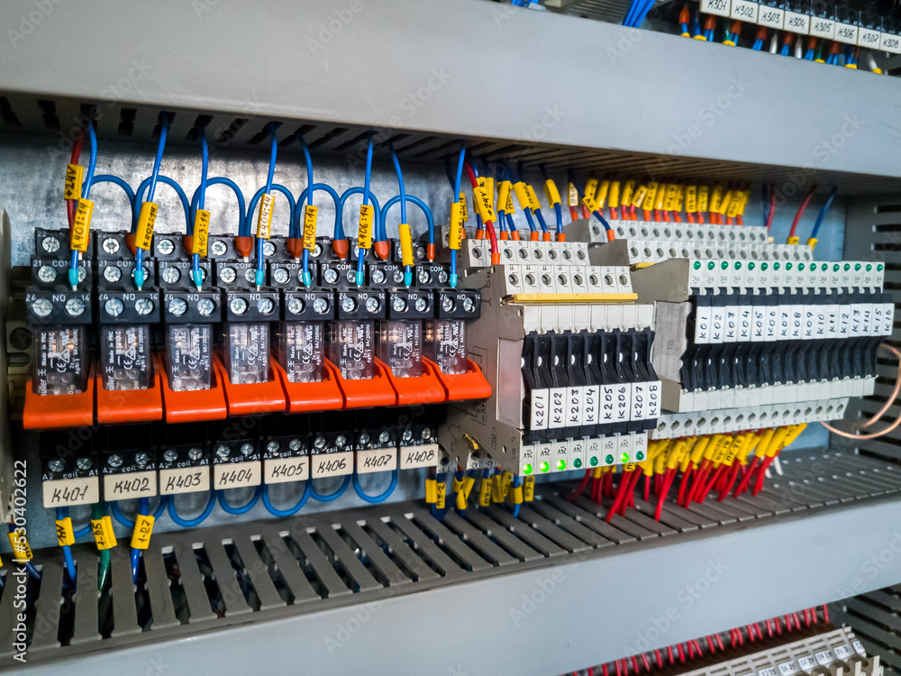 Row of fuses and relays installed in electrical cabinet of automation ...