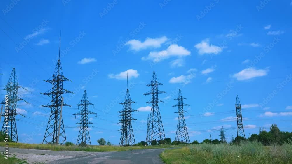 Lots of towers with high-voltage electrical wires along the road ...