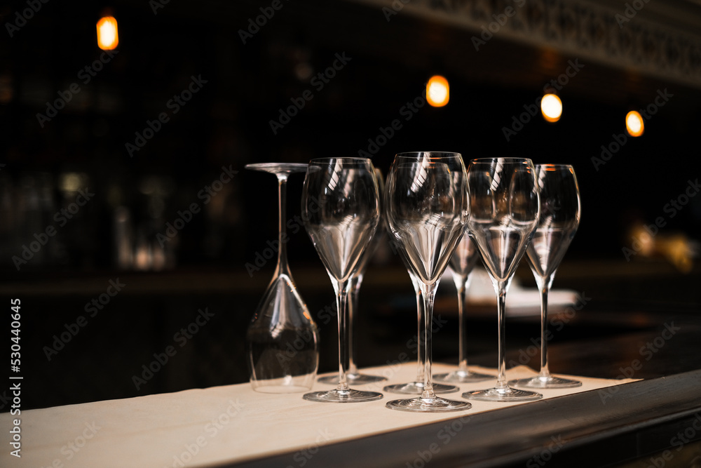 clean empty wine glasses on the bar counter in the restaurant close-up ...