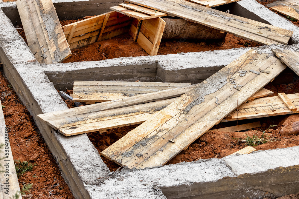 Dismantling the strip foundation formwork at the construction site ...