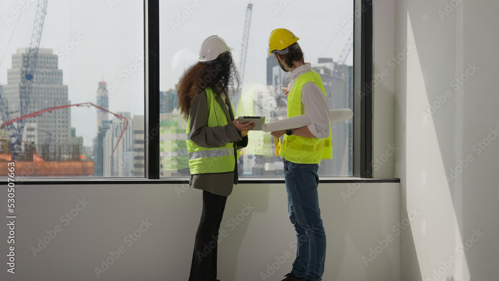 Couple of professional architects workers using tablet brainstorming ...