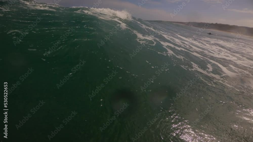 Surfer doing a perfect barrel. first strong layback and big snap to ...