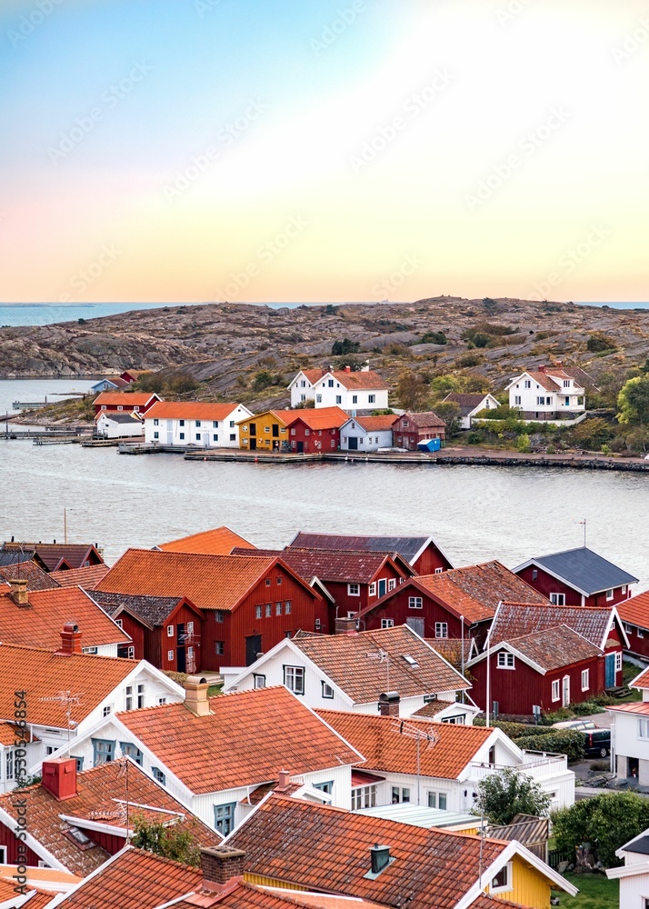 Vertical view of waterside buildings on the coasts under the sunset sky ...