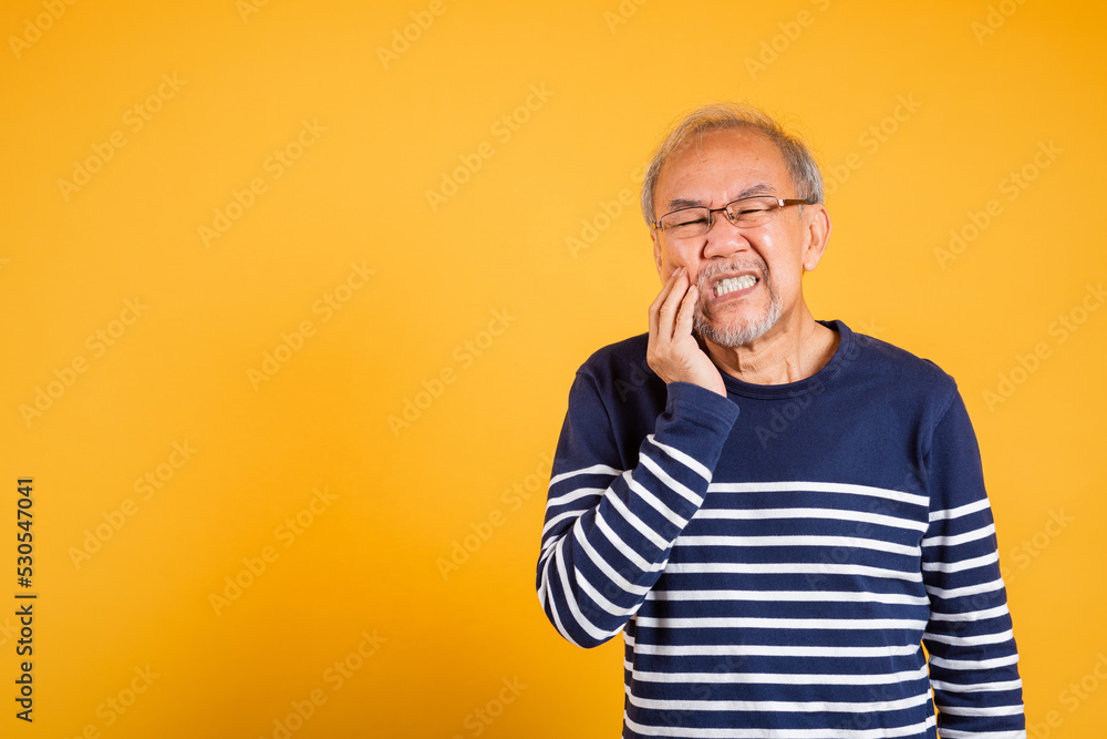 Dental pain. Portrait senior old man sad hand touching cheek suffering ...