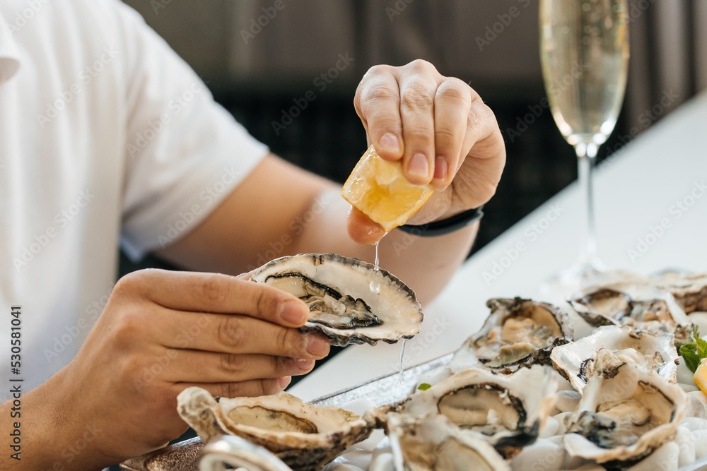 oyster. Man eating shellfish. Seafood and Mediterranean cuisine with ...