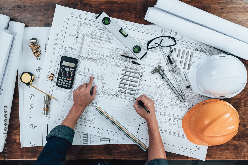 Top view Engineering working with drawings inspection and writing on ...