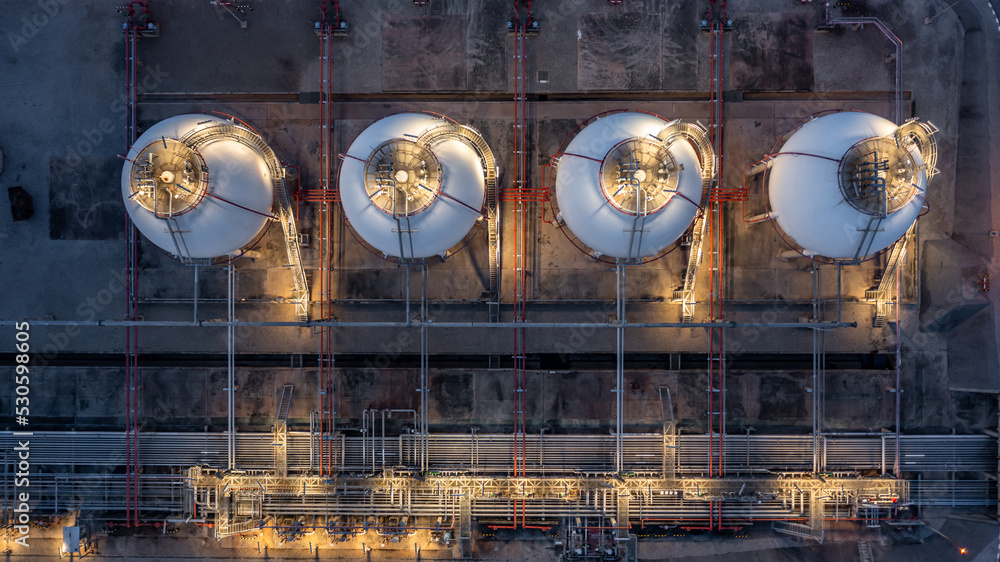 Aerial view spherical tanks for petrochemical plant at night ...