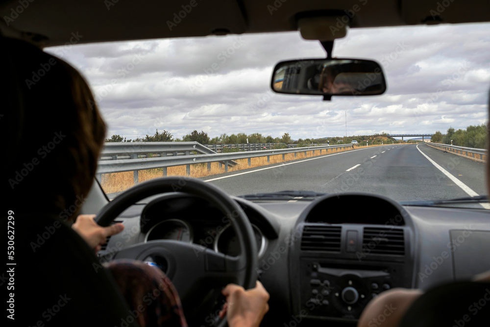 Young Caucasian girl sitting on the seat of a car looking back. Photo ...