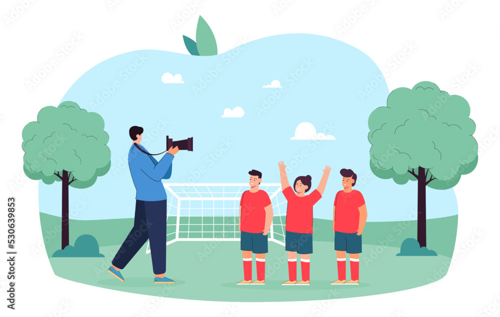 Cameraman filming children in uniform on football field. Man with ...