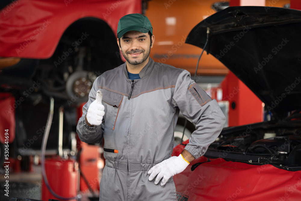 Portrait automobile mechanic man standing showing thumbs up with ...