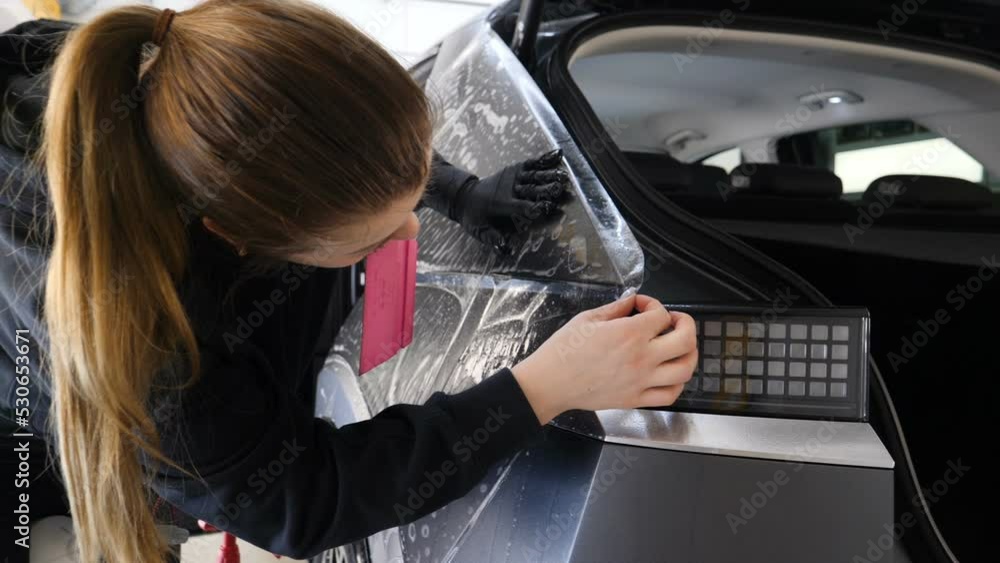 Close up to PPF installation process on a front headlight and hood. PPF ...