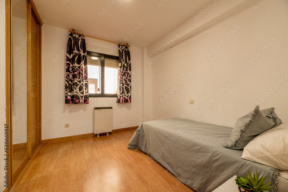 bedroom with a single bed with wooden furniture, wooden floors, brown ...