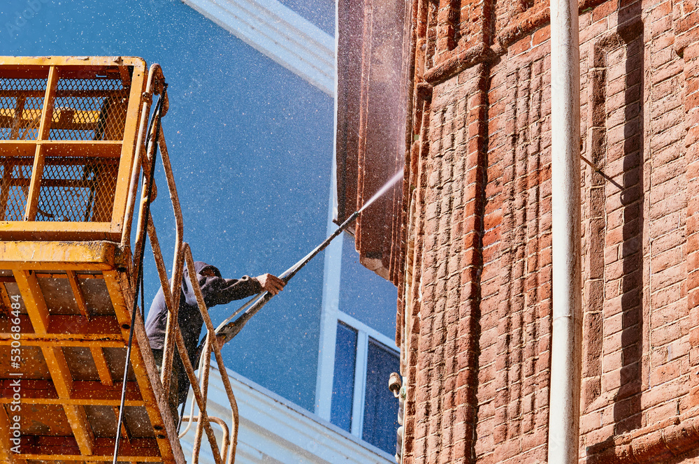 Water jet cleaning of facades. High pressure washing of the facade of a ...