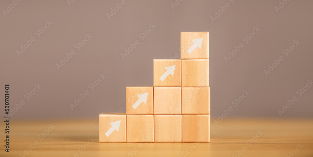 wooden block arrangement. with an arrow up like a graph. The process of ...