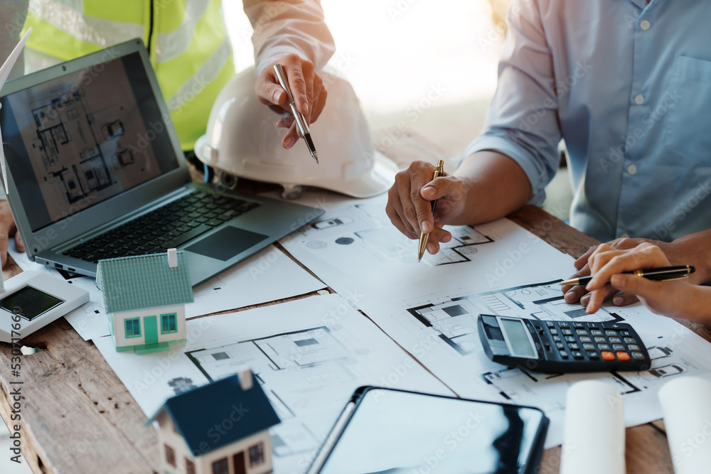 Architect or engineer are designing house, modifying plan, creating ...