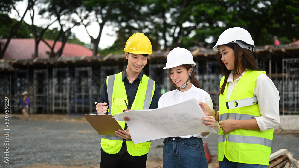 Architect and engineer in safety helmet and reflective jackets are ...