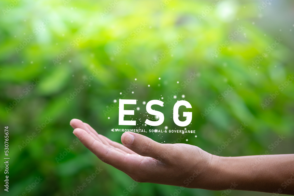 ESG text in hand of human, environmental, social, and governance in ...