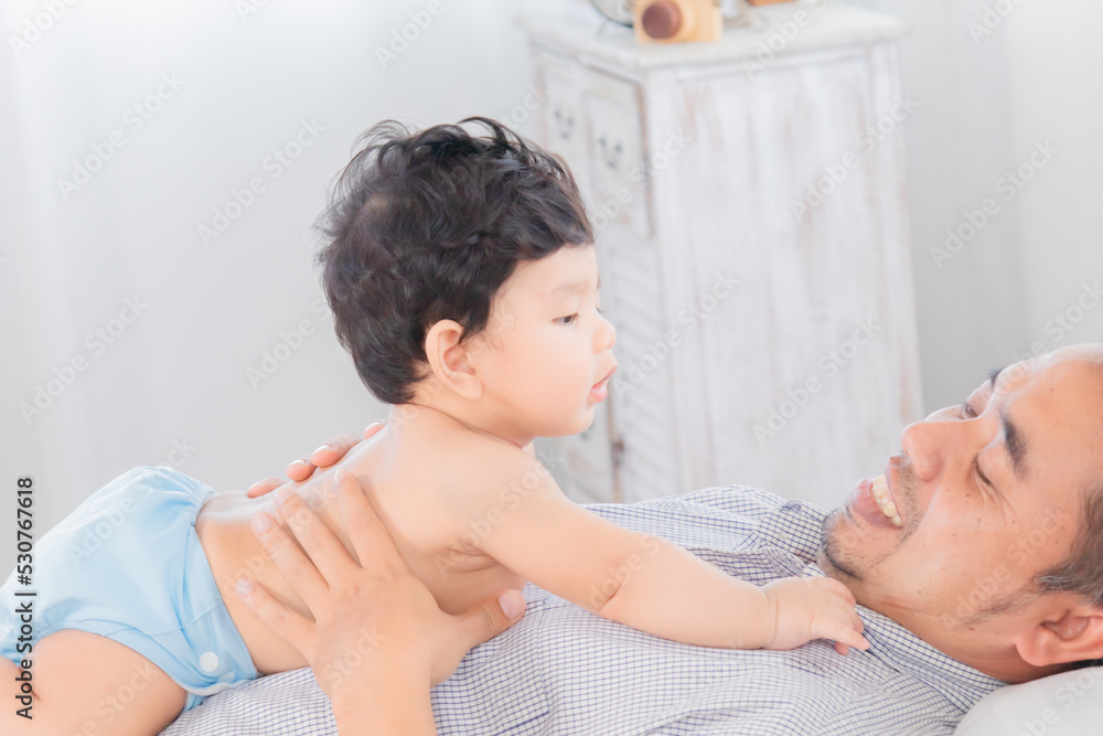 Selective focus happy asian father playing and look into eyes with ...